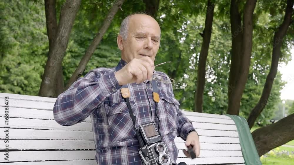 elderly man with a receding hairline and gray hair photographer with a ...