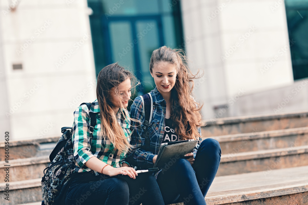 Teen girls engaged in happy conversation meeting together in the bright ...