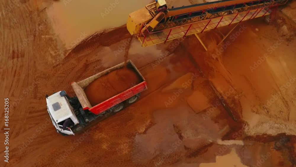 Mining conveyor loading sand in dump truck. Sand work. Mining conveyor ...