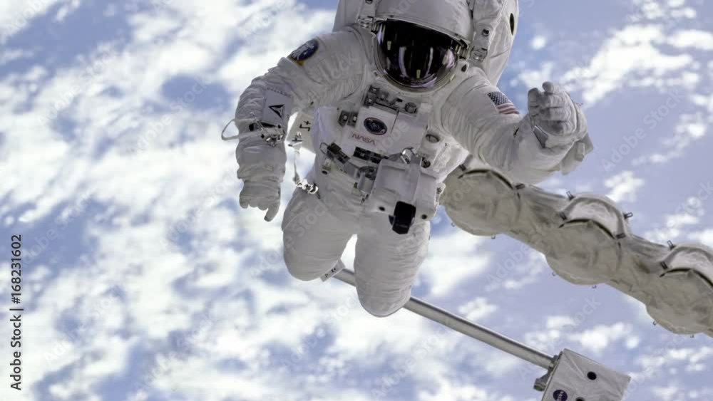 Astronaut are moving in the camera in outer space against the Earth ...