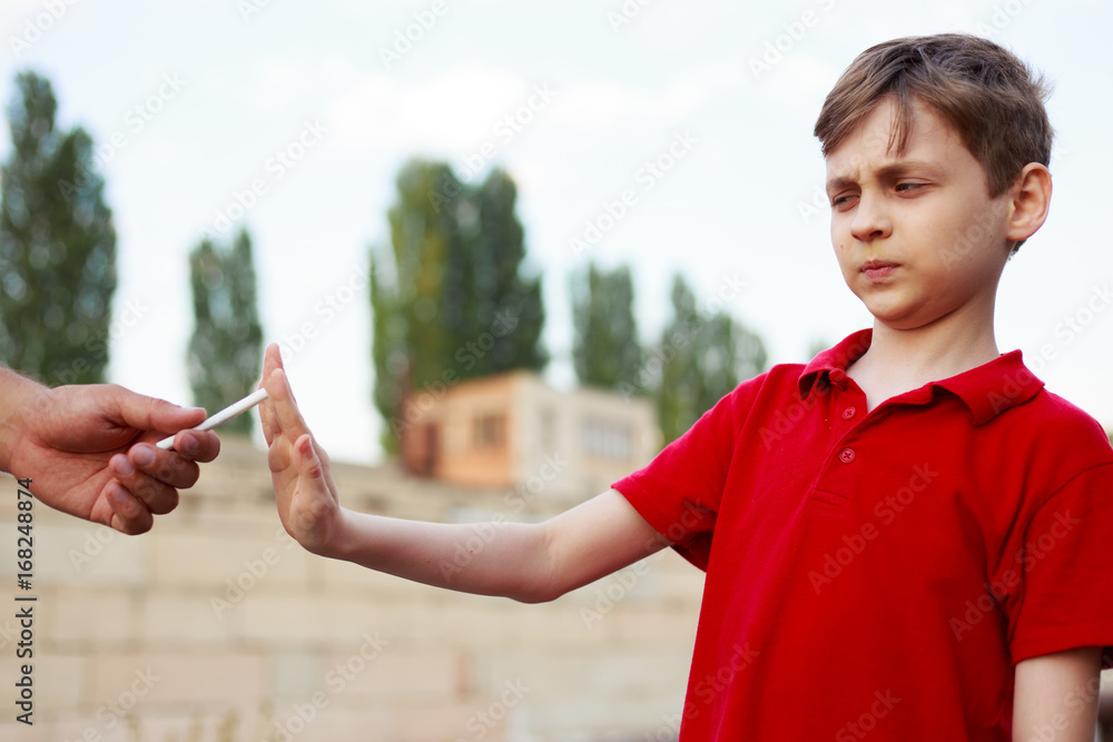 Stop smoking for children. Schoolboy refuse the proposed cigarette. Bad ...