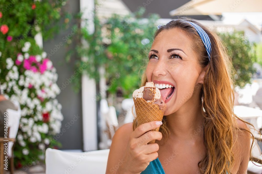 Beautiful young girl eating ice cream Stock Photo | Adobe Stock
