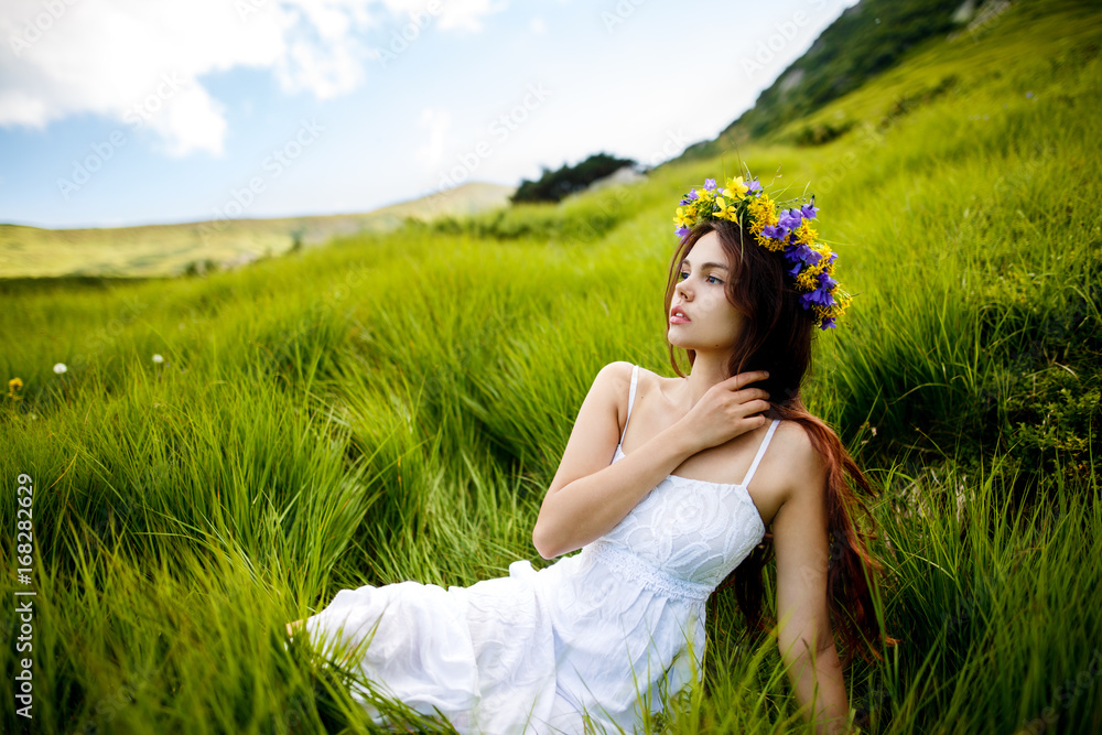 Beautiful woman in a long white dress in the mountains. Young woman ...
