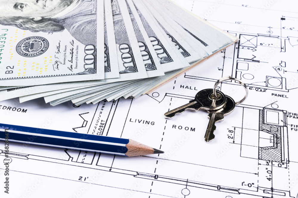 Stack of money with key lying on construction drawing of house ...