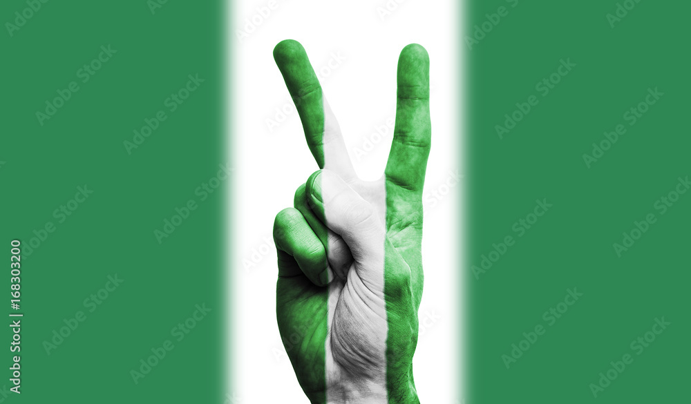 Nigeria national flag painted onto a male hand showing a victory, peace ...