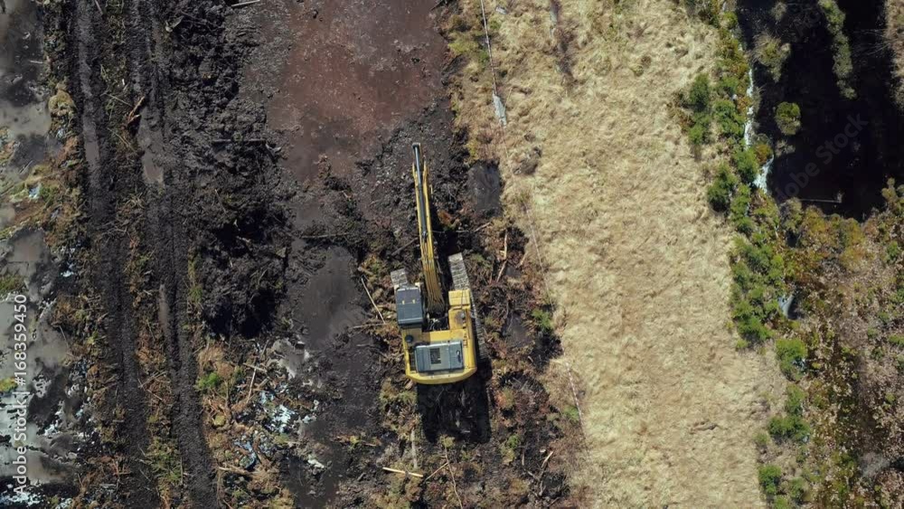 Sky view industrial excavator working on deforestation territory ...