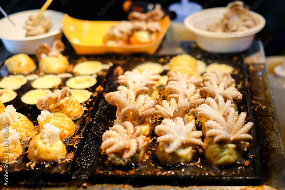 Homemade "Baby Octopus" in Takoyaki Japanese balls on black stove - for ...