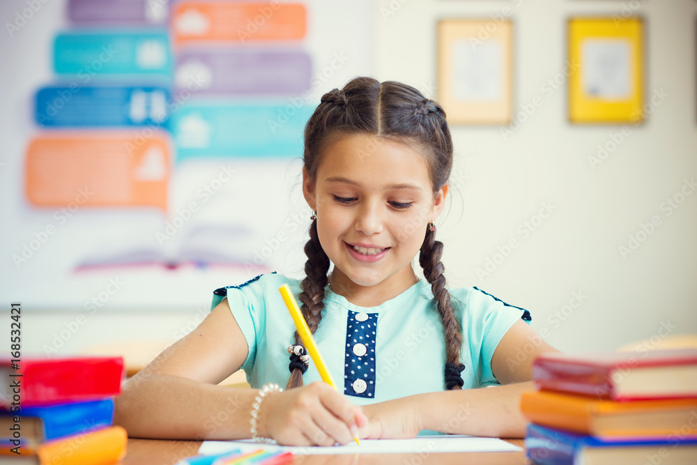 Cute smiling schoolgirl at school Stock Photo | Adobe Stock