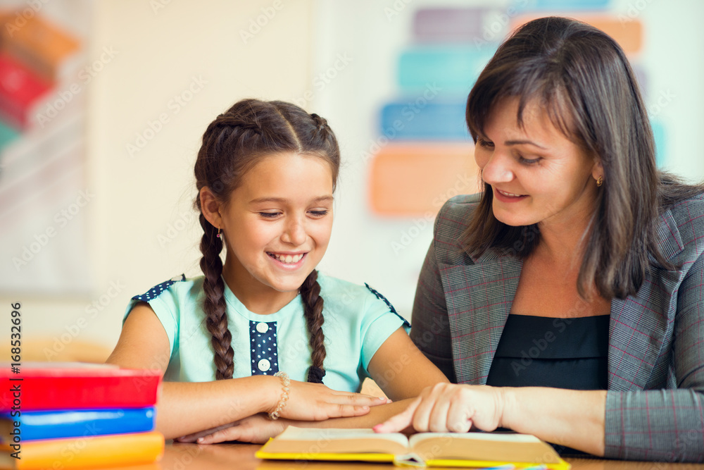 Yong beautiful teacher with schoolgirl school Stock Photo | Adobe Stock