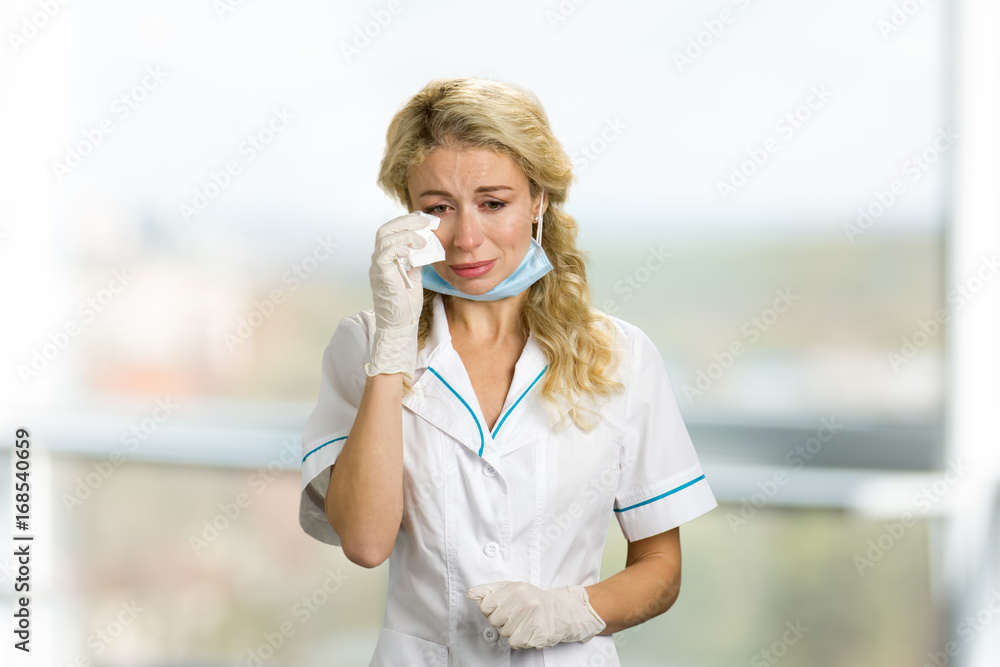 Unhappy crying young female doctor. Upset nurse or female doctor crying ...