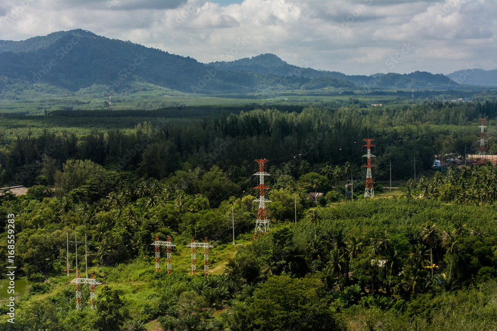 Tower of power lines in the forest. Electric tower line in Landscape ...