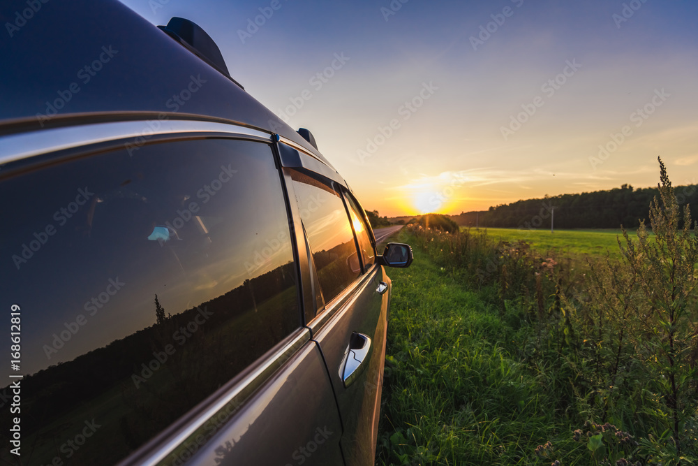 Car on the side of the road sunset Stock Photo | Adobe Stock