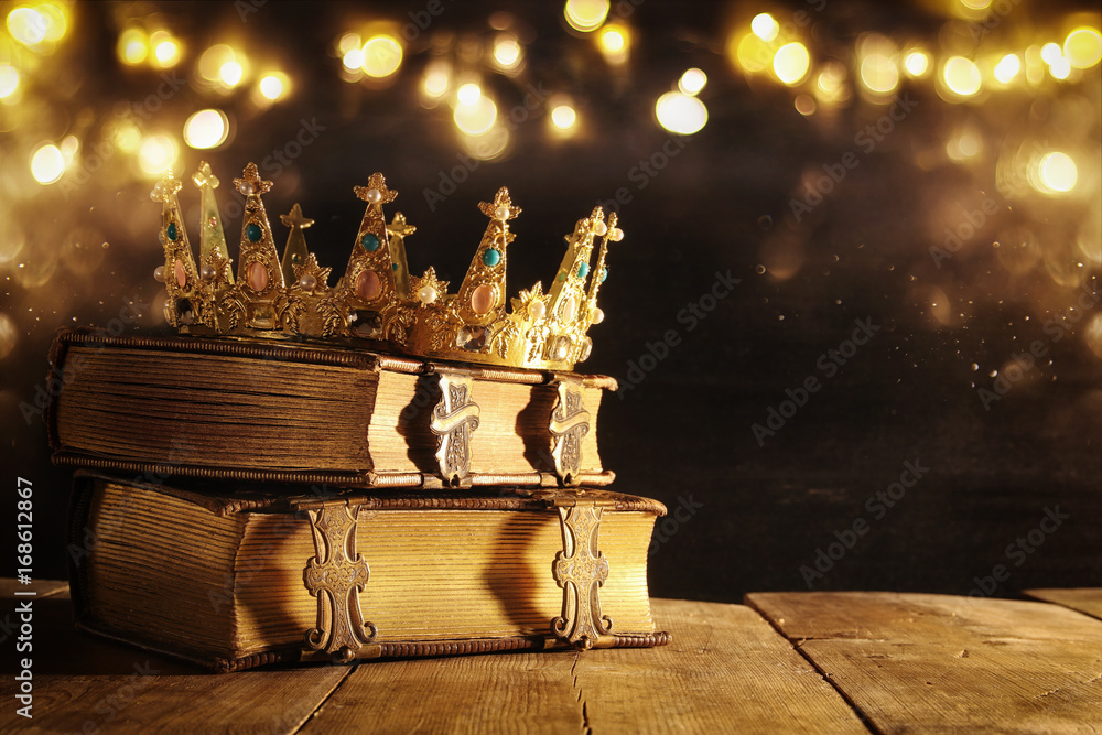 beautiful queen/king crown on old book. vintage filtered. fantasy ...