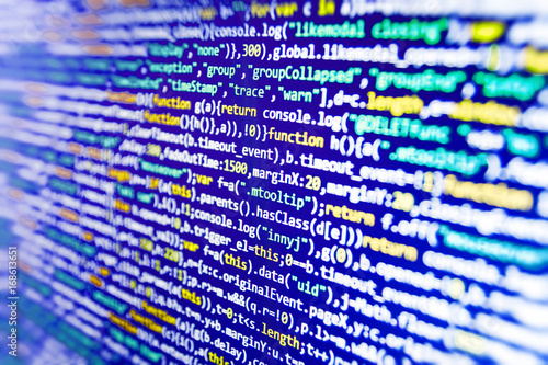 Big data and Internet of things trend. Software source code. Programmer typing new lines of HTML ...