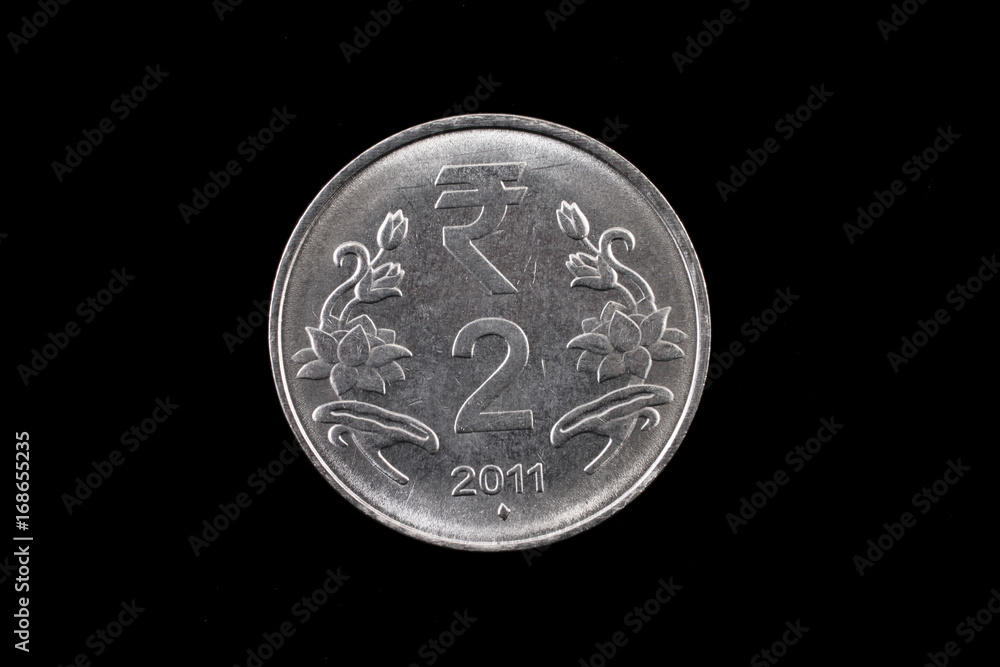 An extreme close up of an Indian two rupee coin on a solid black ...