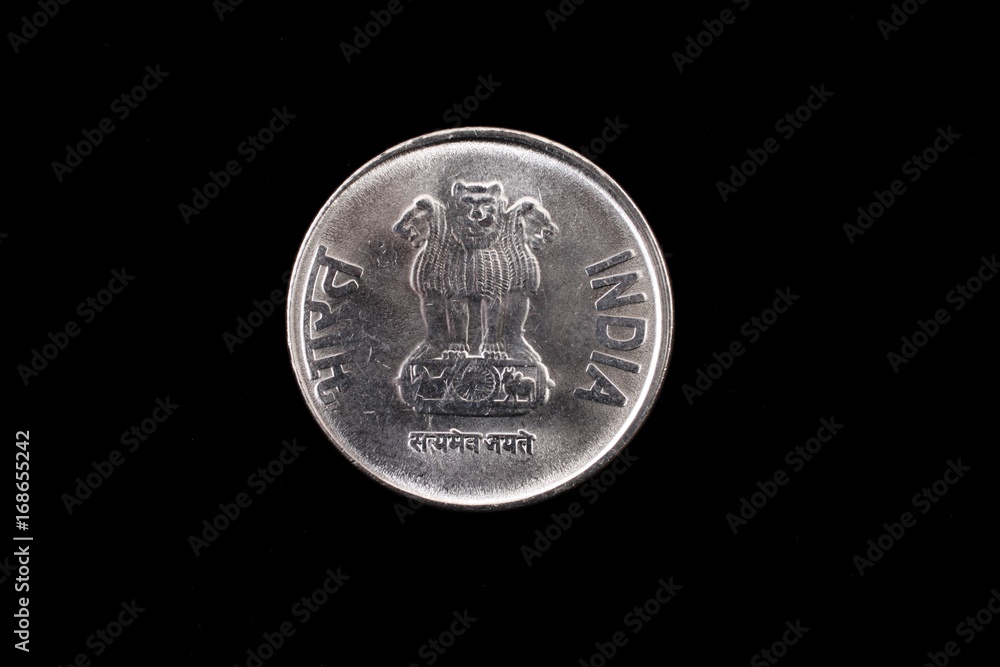 An extreme close up of an Indian one rupee coin on a solid black ...