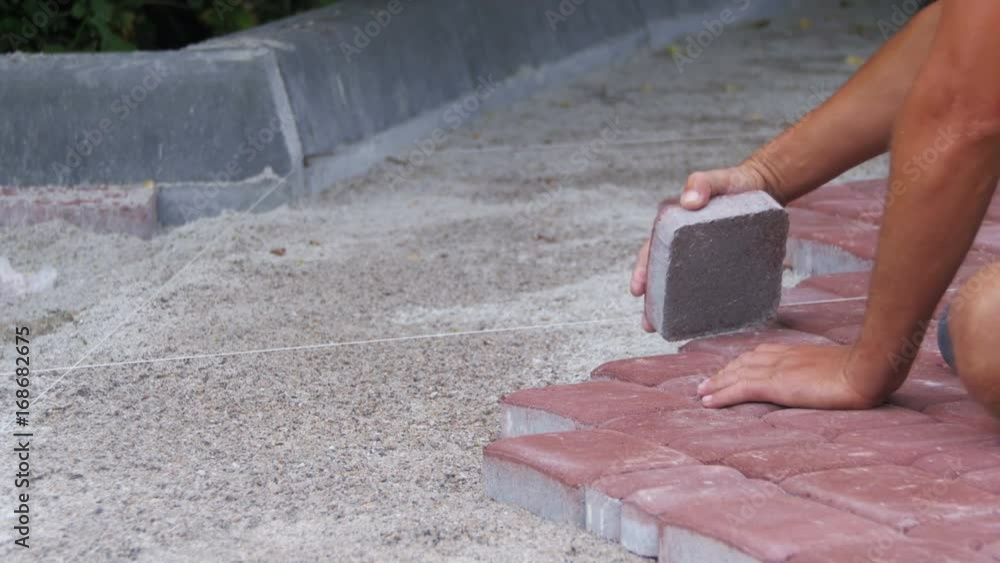 Laying Paving Stones. Worker is Laying Paving Stones using Hammer ...