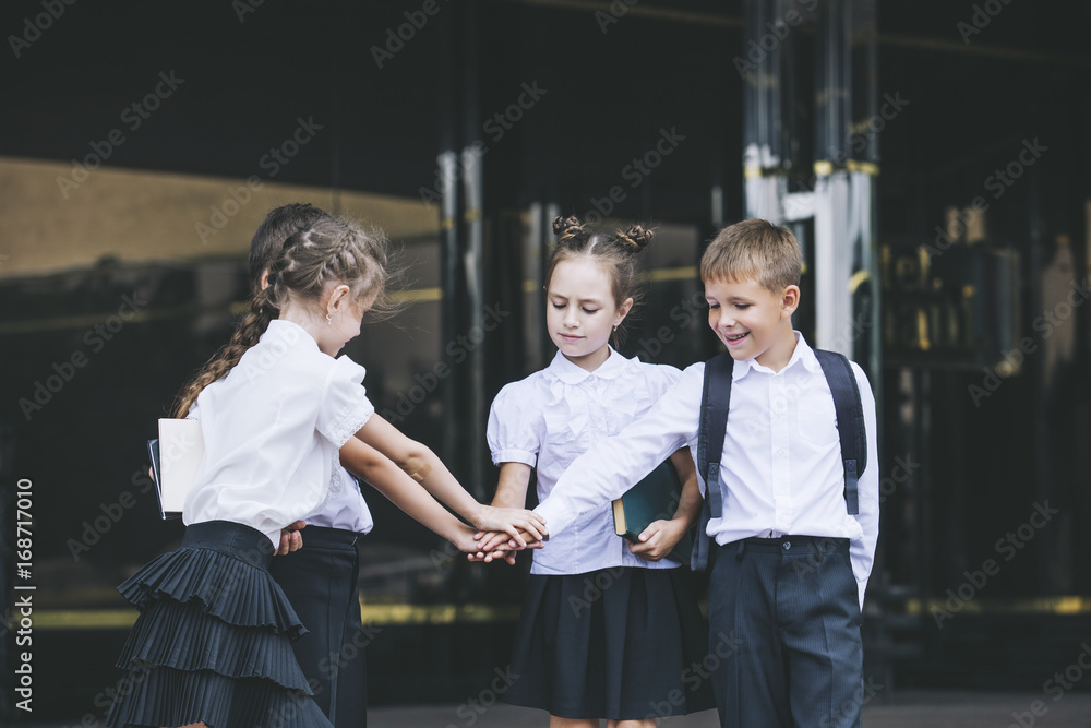 Beautiful school children active and happy on the background of school ...