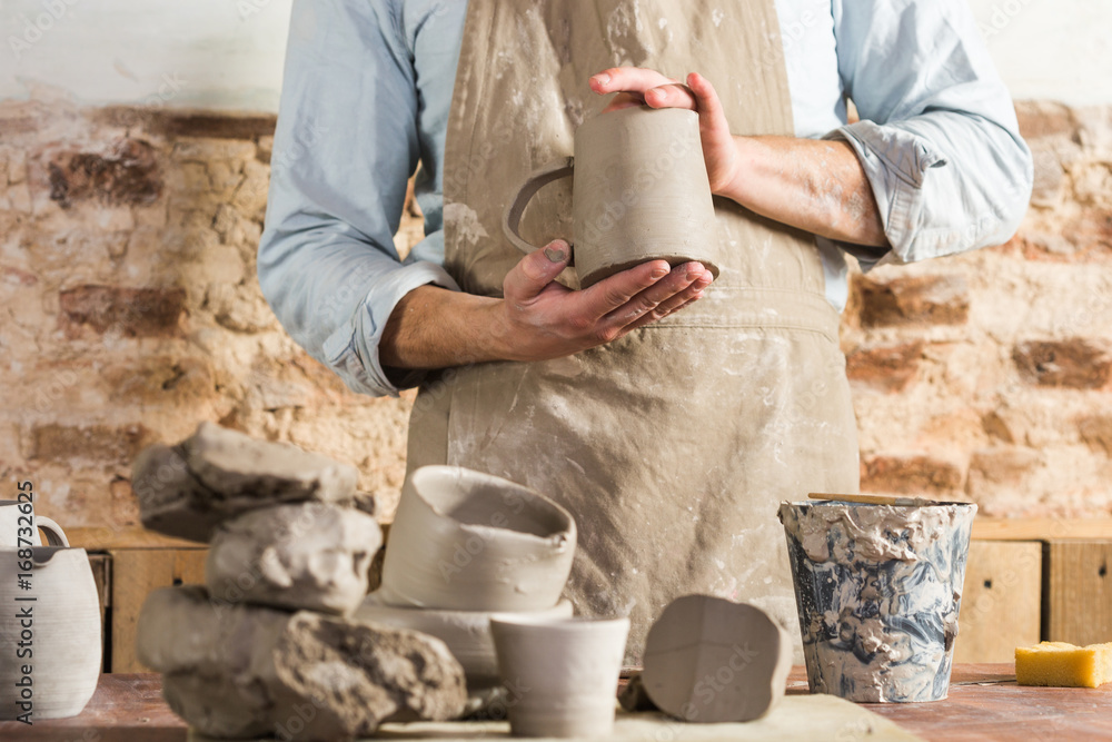pottery, workshop, ceramics art concept - male ceramist stand at a ...