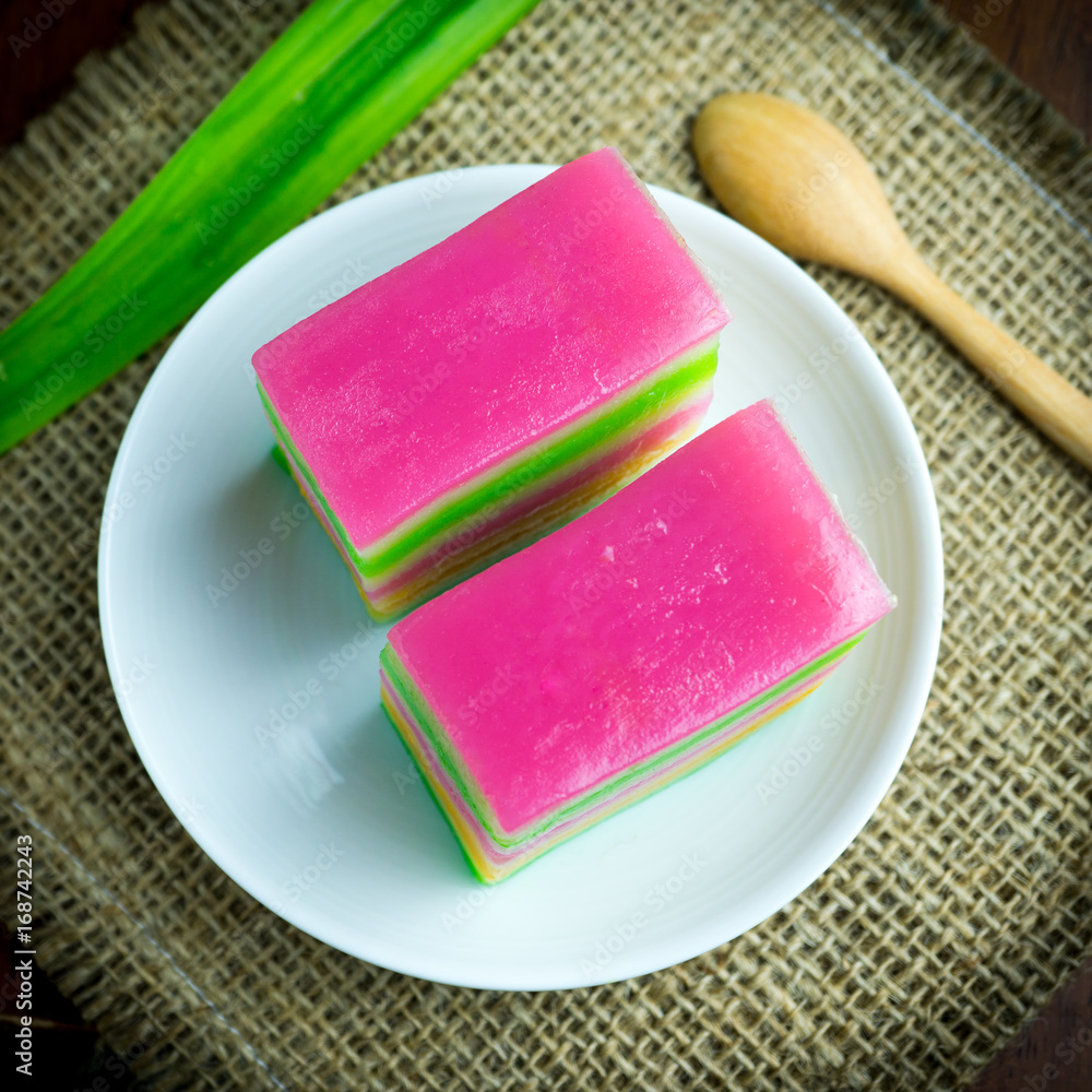 Asian snack, sweet layer steam cake with a transparent round cup of tea ...