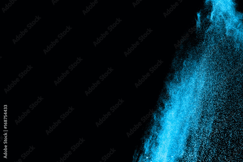 Abstract blue powder splatted on white background. Freeze motion of ...