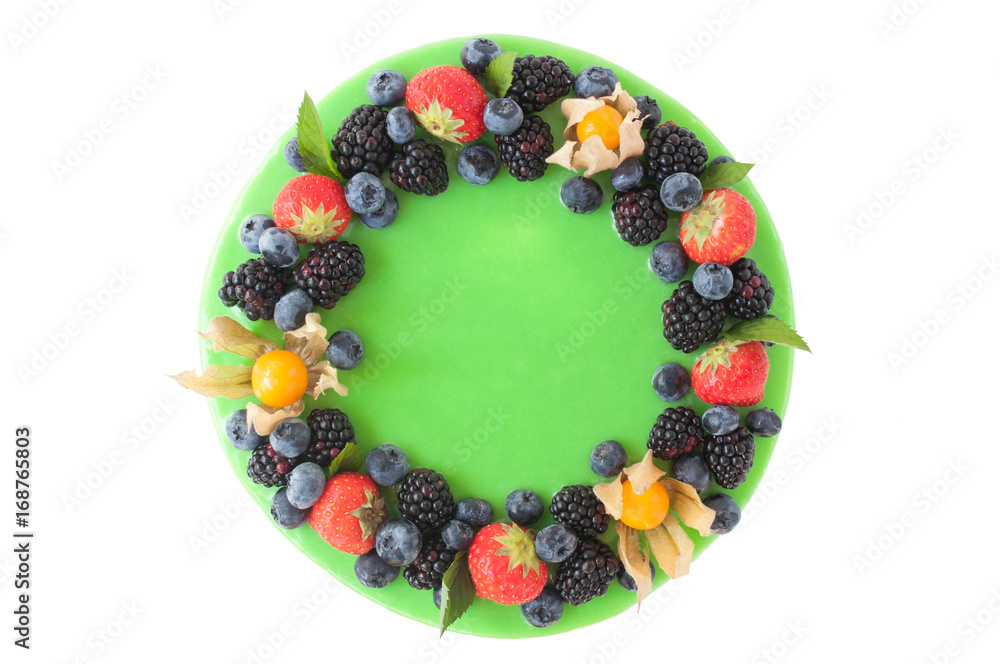 Birthday cake in green glaze, decorated with strawberries, blueberries ...