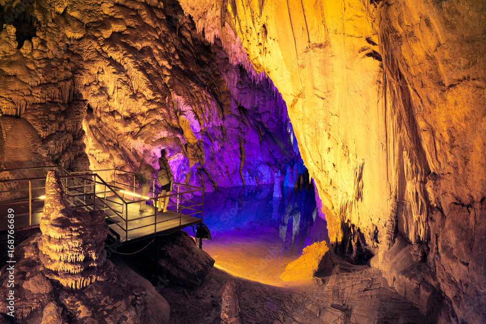 People admire the beauty of underground lake in Dim cave. Valley of Dim ...