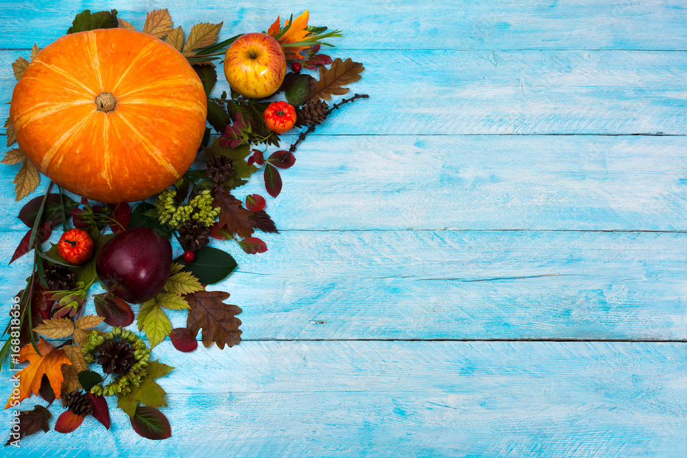 Happy Thanksgiving greeting with fall leaves on blue wooden background ...