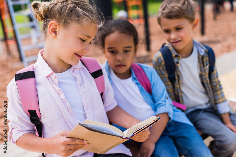 multiethnic schoolkids reading book Stock Photo | Adobe Stock