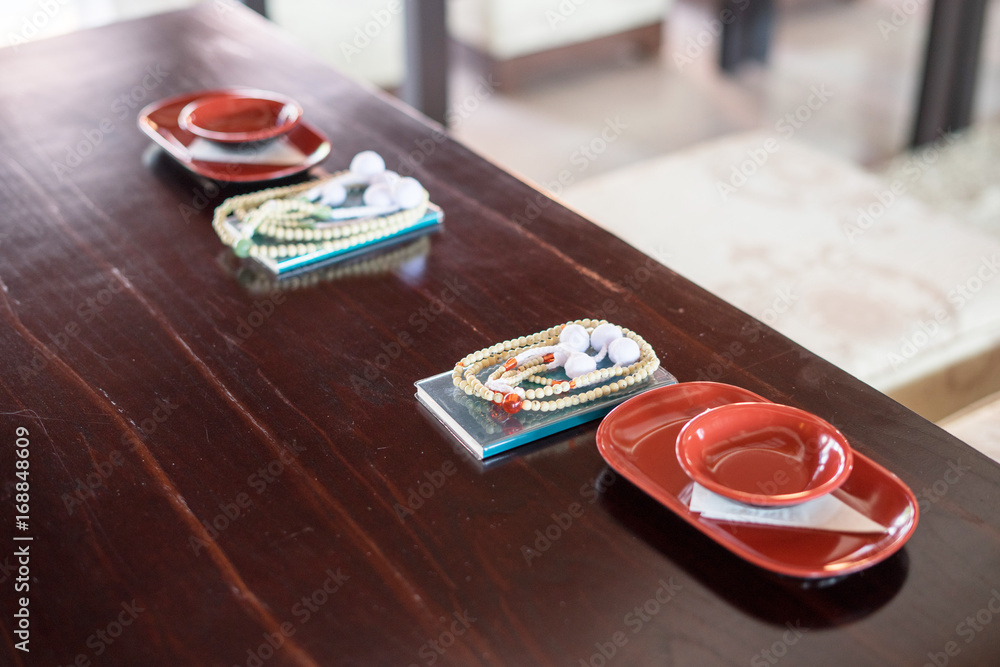 Prayer book and sake cup couple on table for drink sake ceremony in ...