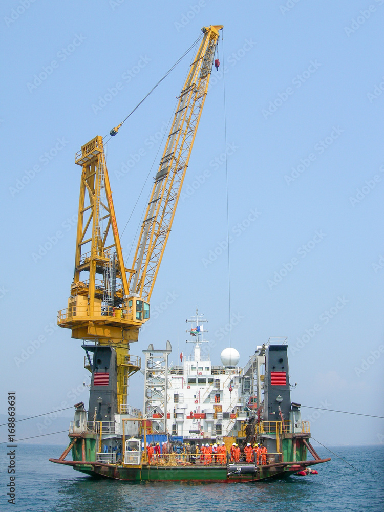 Offshore construction vessel working on subsea installation with large ...
