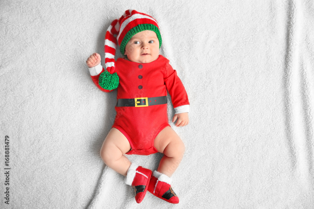 Cute little baby in Santa costume lying on soft fabric Stock Photo ...