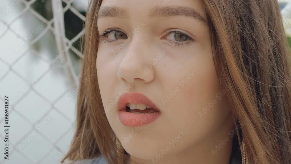 Seductive looking and posing at camera by teen female model. Slowly ...