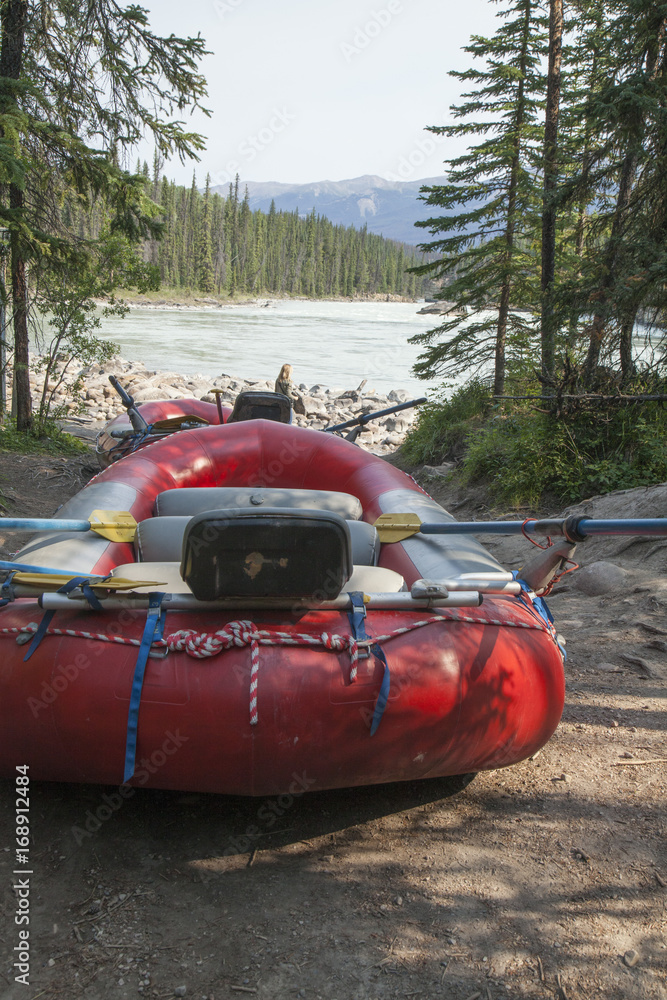 A red inflated river raft is ready for passengers for a day on the ...