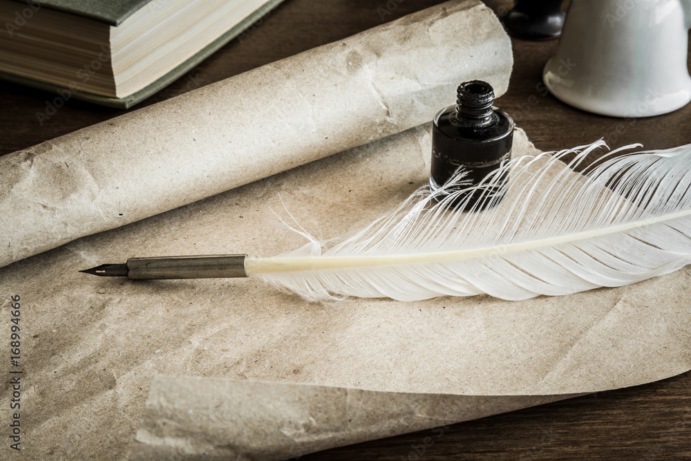 Old quill pen on the old paper. Letter writing. Historical atmosphere ...