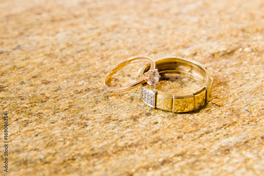 Wedding rings on a natural stone with inclusions of native gold. Offer ...