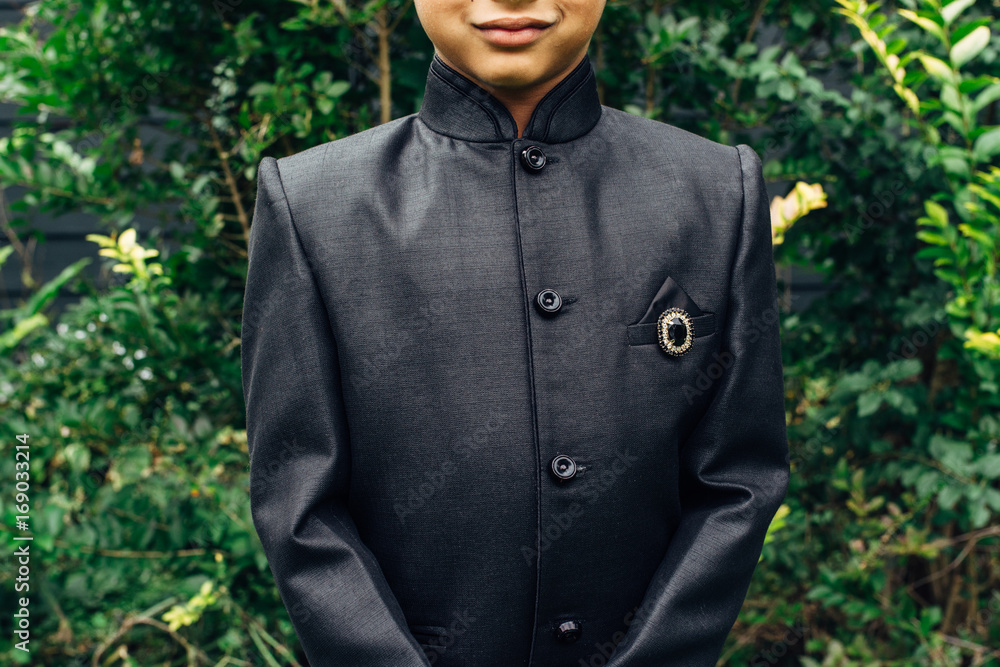 Smiling Indian boy wearing a traditional wedding outfit Stock Photo ...