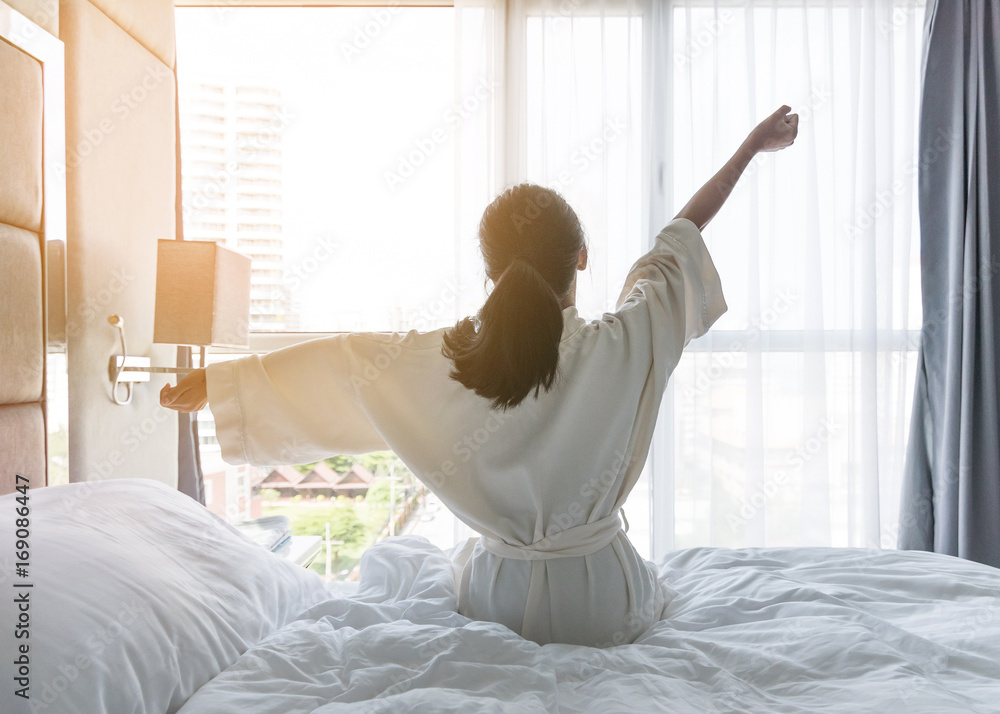 Easy lifestyle young Asian girl waking up in the morning taking a rest ...