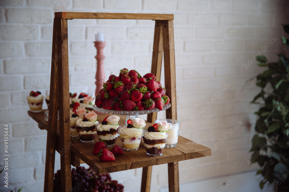Candy bar. Table with sweets, buffet with cupcakes, candies, dessert ...