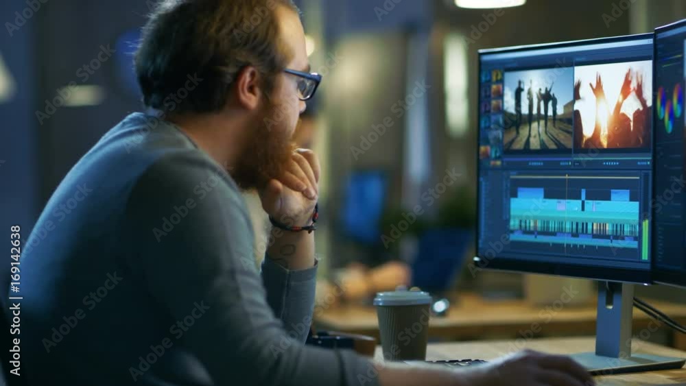 Male Video Editor Works with Footage and Sound on His Personal Computer ...