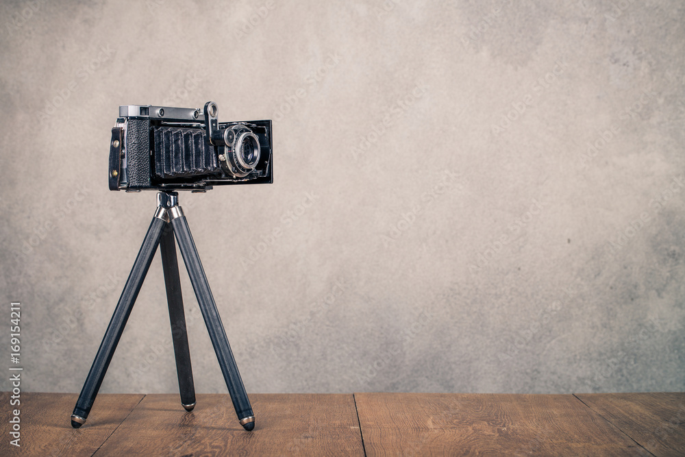 Old retro outdated film camera on tripod. Vintage instagram style ...