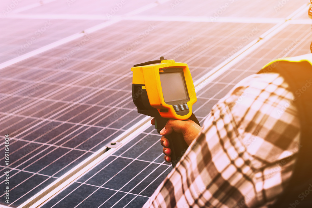 engineer checking heat of solar panel and using ir camera to scan ...