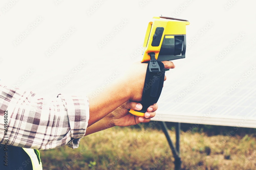 engineer checking heat of solar panel and using ir camera to scan ...