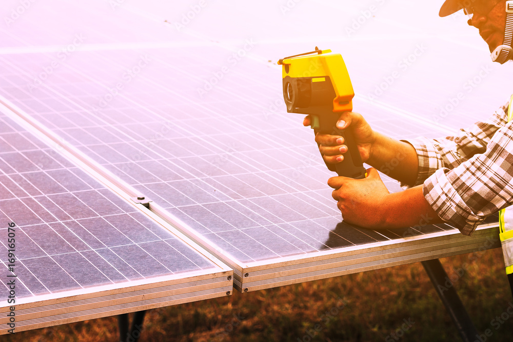 engineer checking heat of solar panel and using ir camera to scan ...