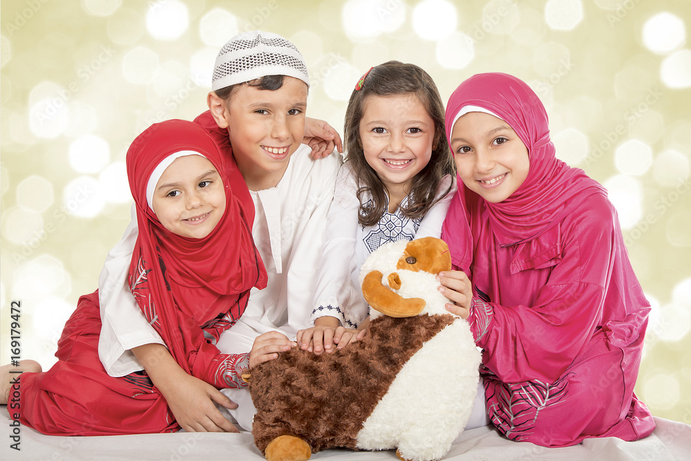 Happy little Muslim kids playing with sheep toy - celebrating Eid ul ...