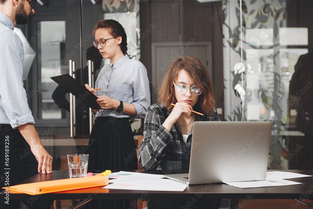 Young professionals are working on a new startup in a modern loft ...