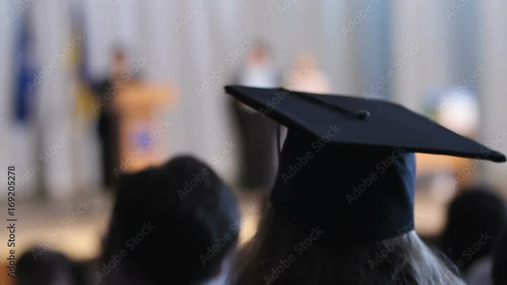 Graduate receiving diploma at stage, students watching graduation ...
