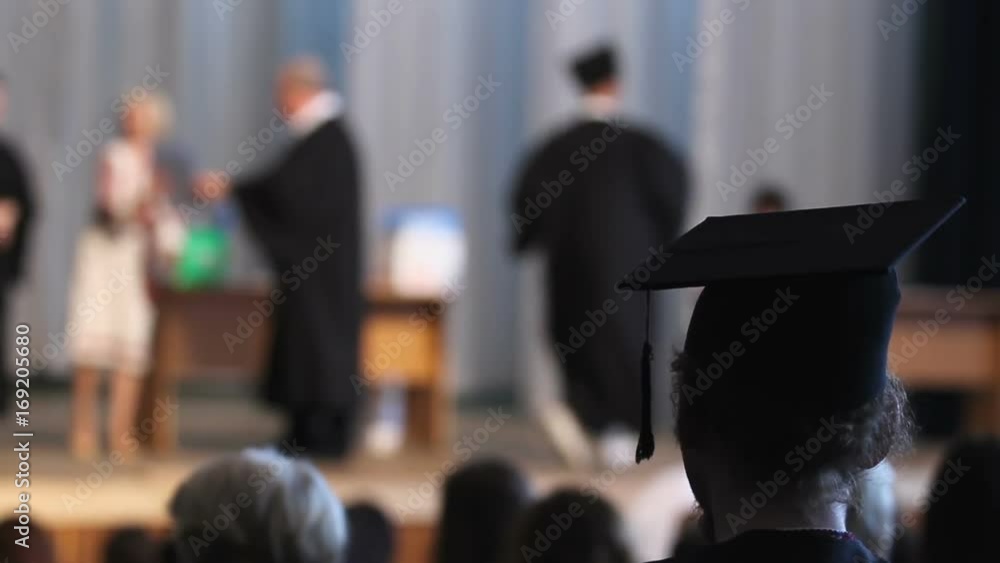 Student looking on stage at graduation ceremony, people receiving ...
