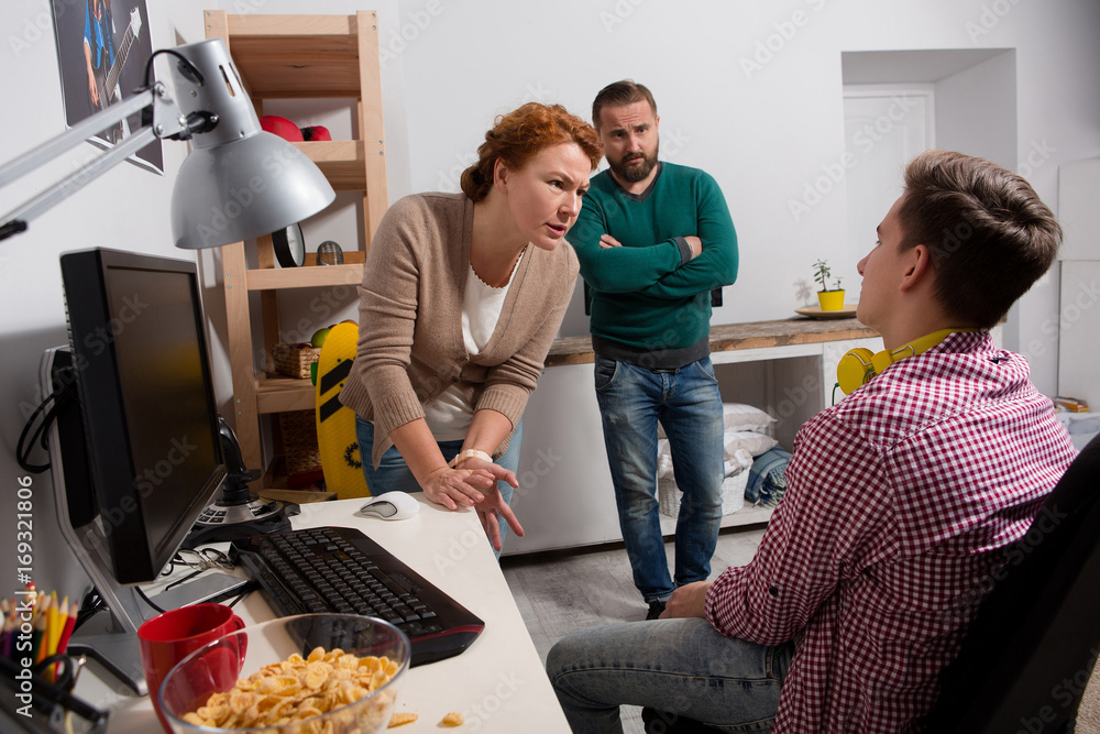 Parents arguing with teenage son. Misundarstandings between parents and ...