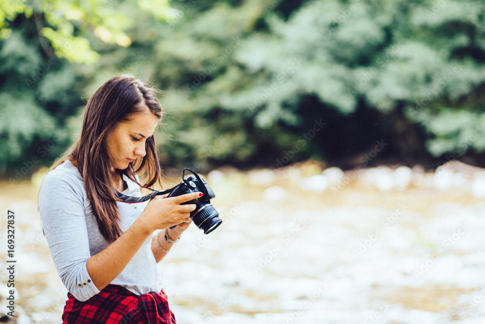 Great looking young girl browsing photos she took with her camera in ...